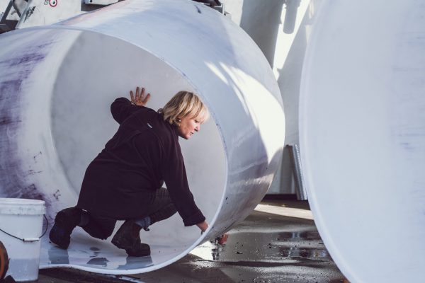 Kate cleaning open fermenter – The Real Review